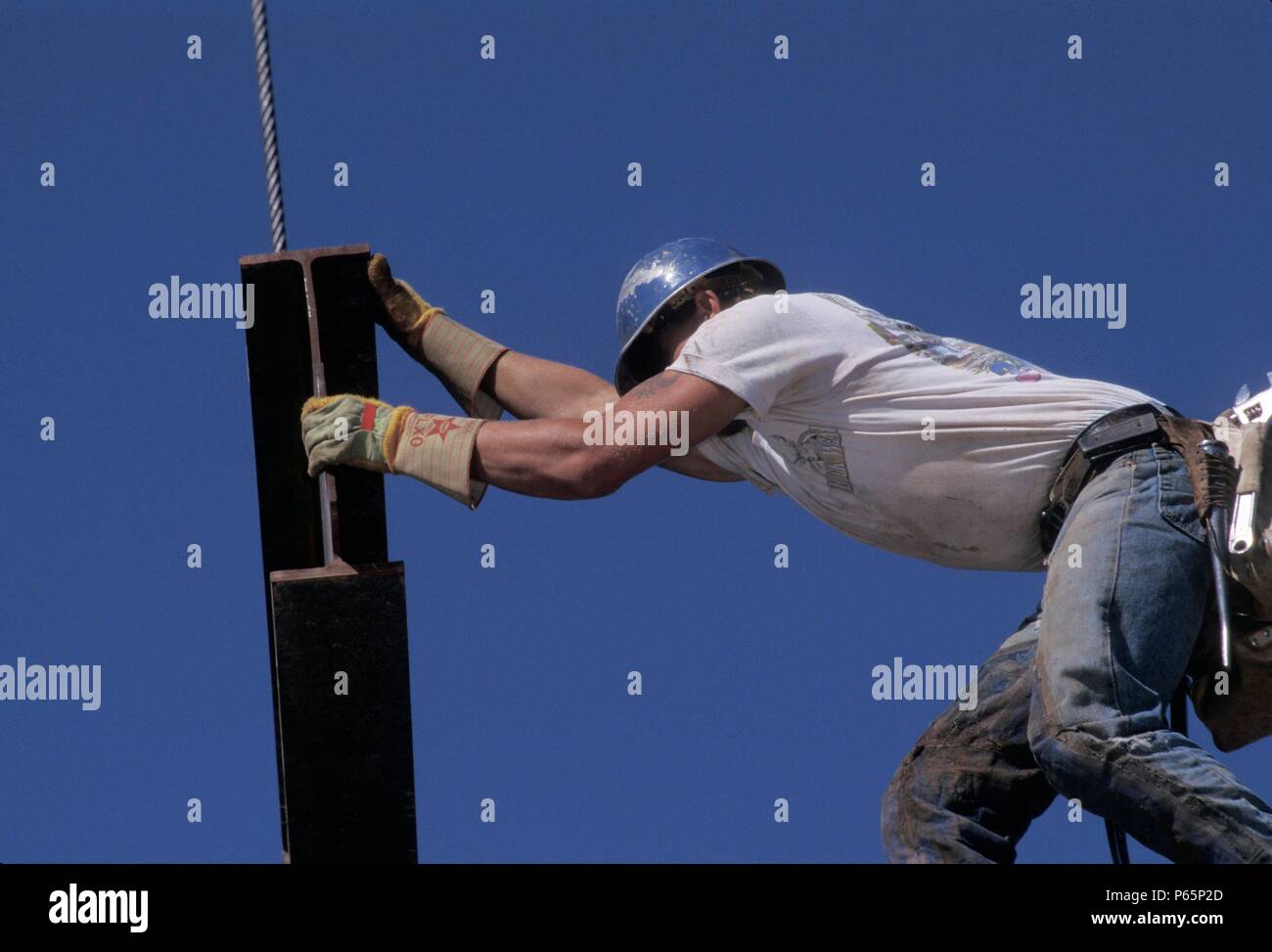 Ironworker connector guiding large beam into position supported by ...