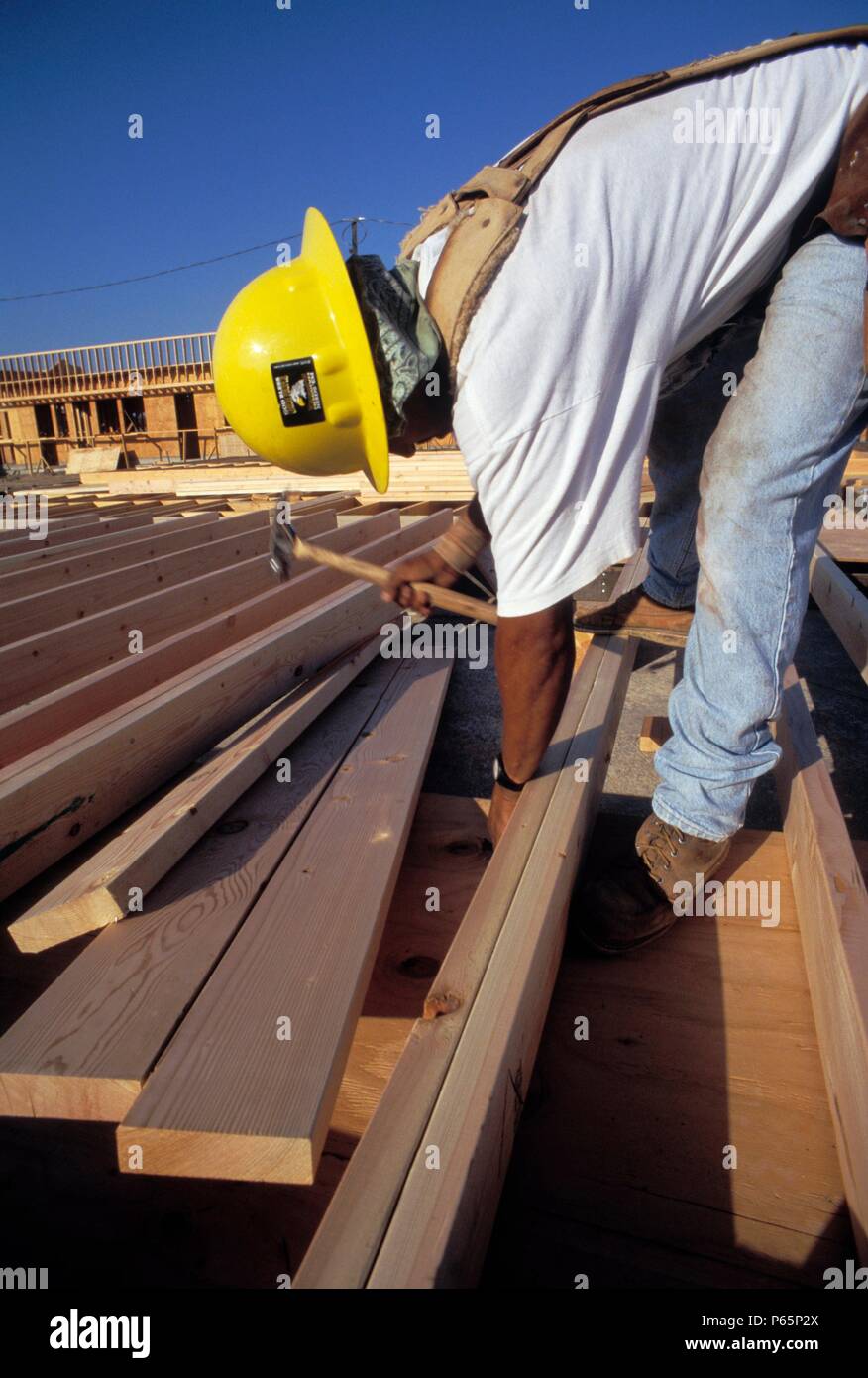 Carpenter building wall for school Stock Photo - Alamy