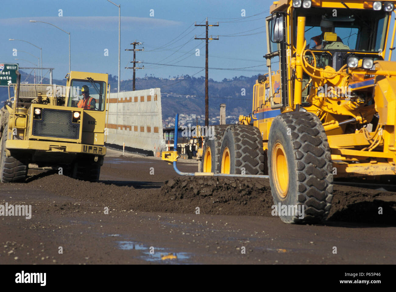 Grader and scraper setting final grade for freeway, Oakland, California ...