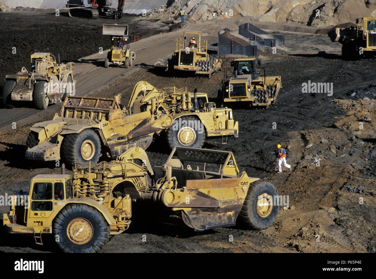 Excavating machines working on giant earthen dam in California, USA ...