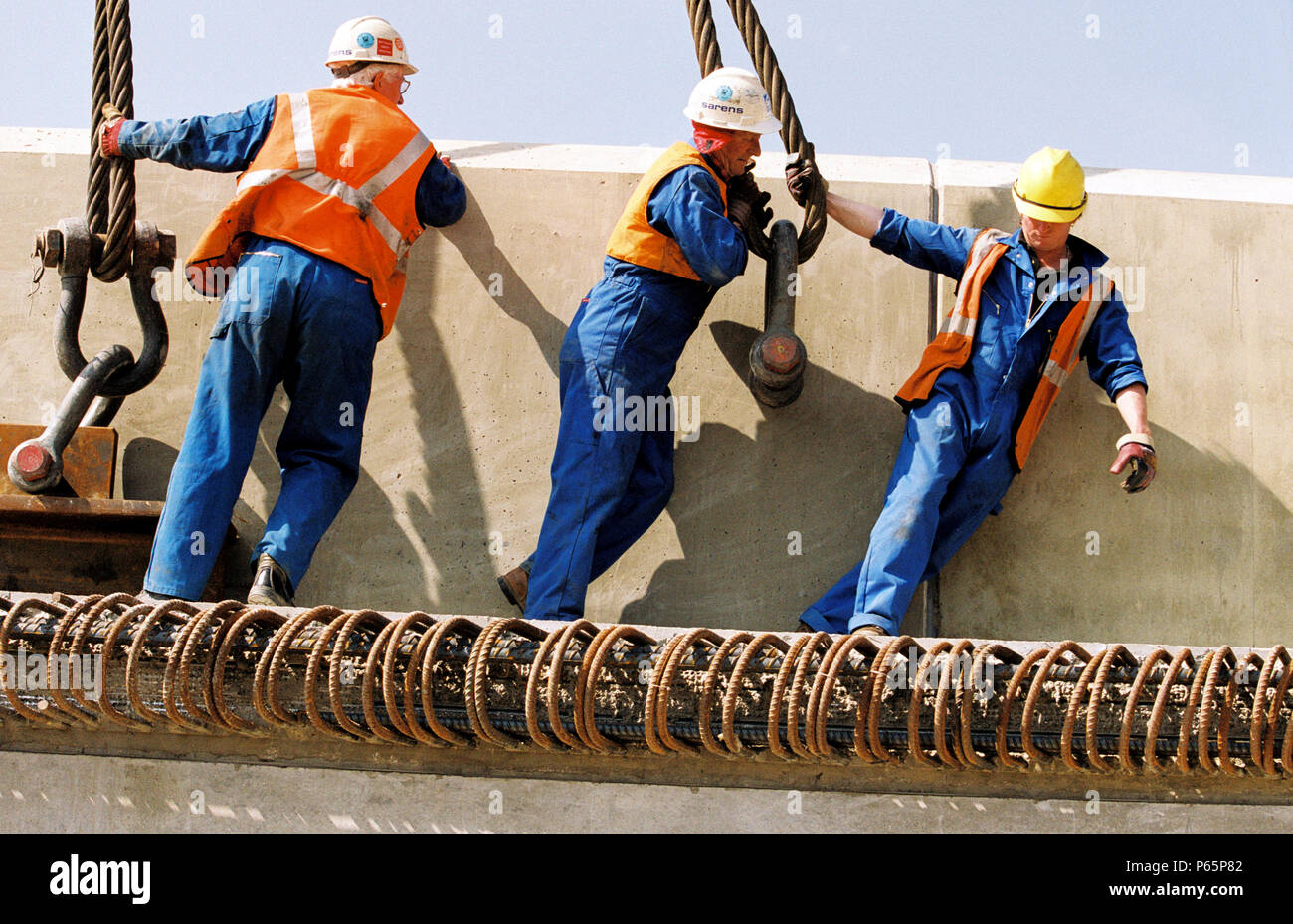 Construction workers in action Stock Photo - Alamy