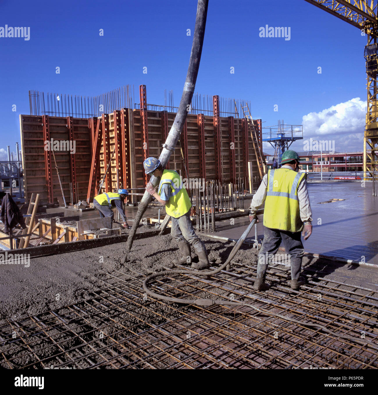 Placing and spreading pumped in situ concrete to reinforced slab Stock ...