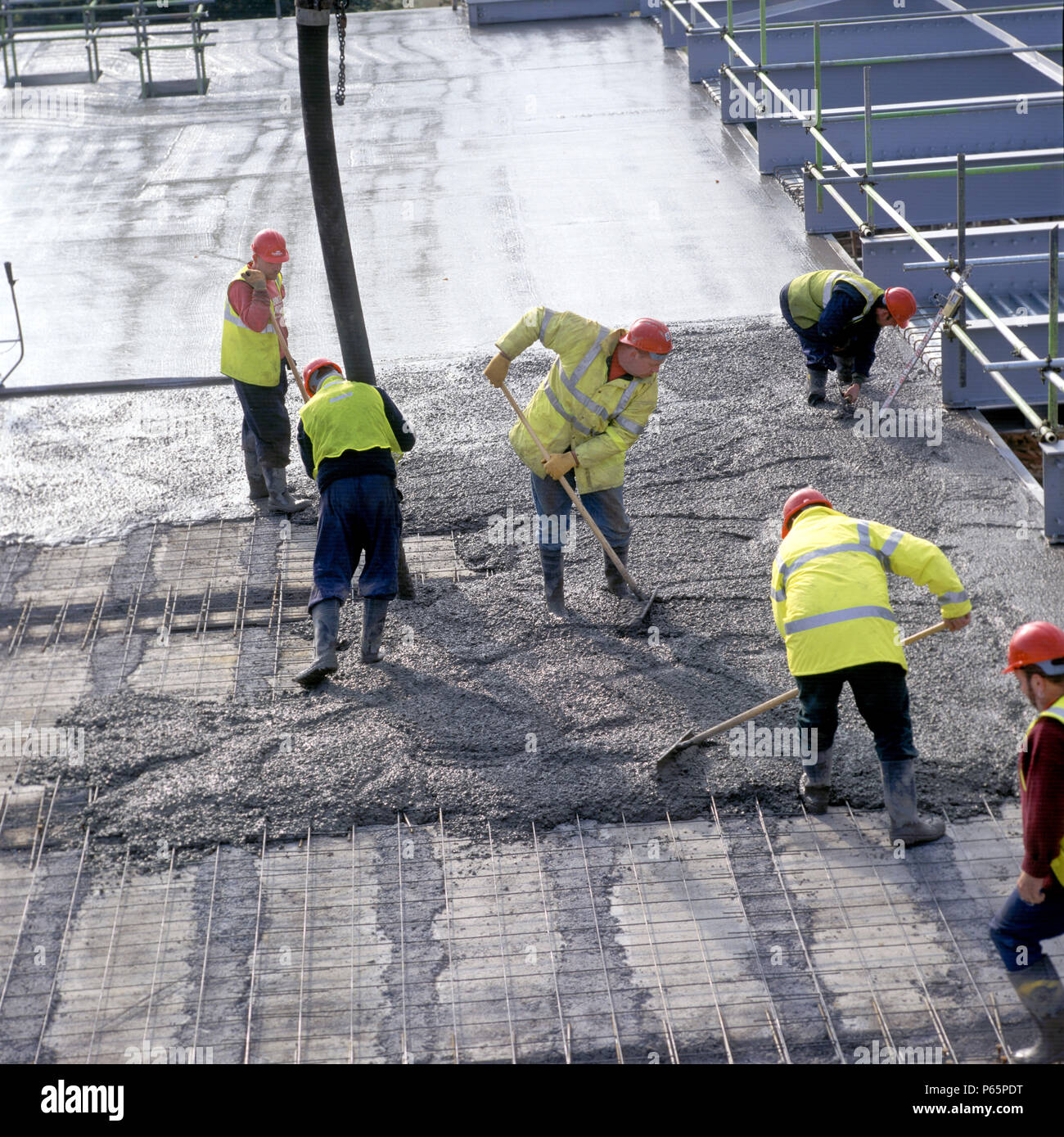 Placing and spreading pumped in situ concrete to reinforced slab Stock ...