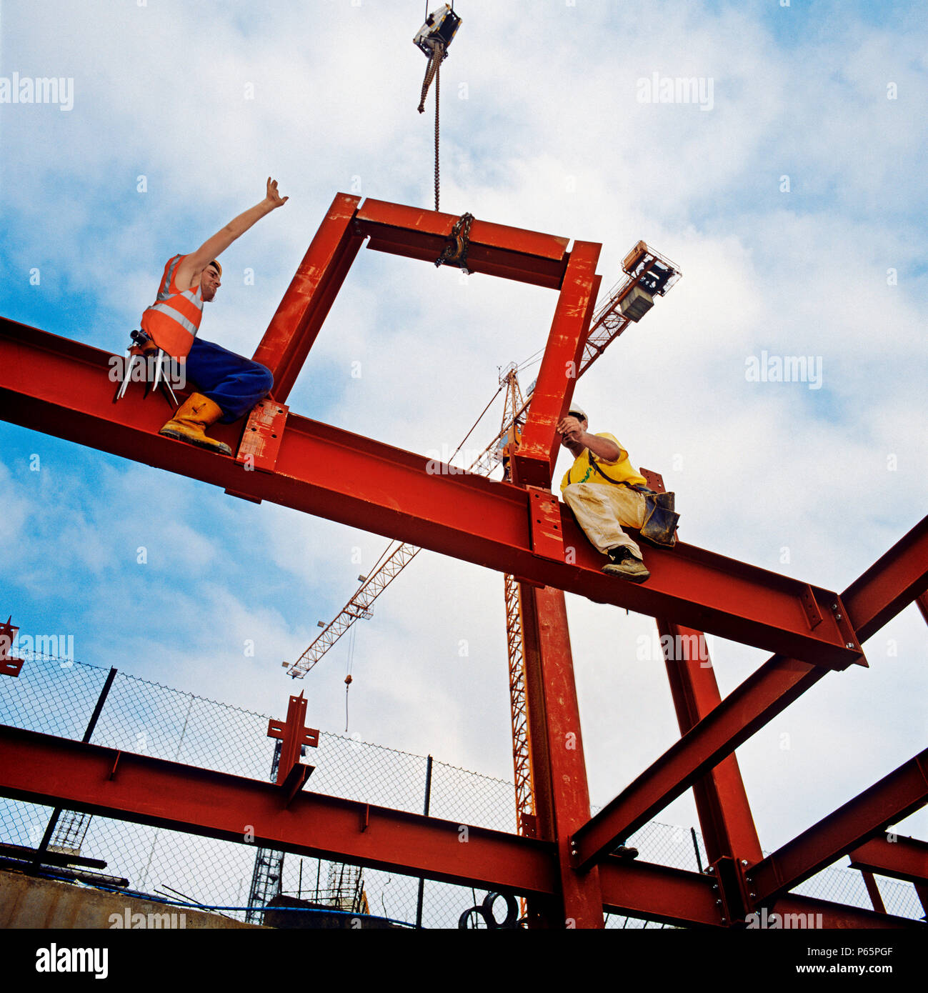Construction workers assembling steel modular structure during the ...