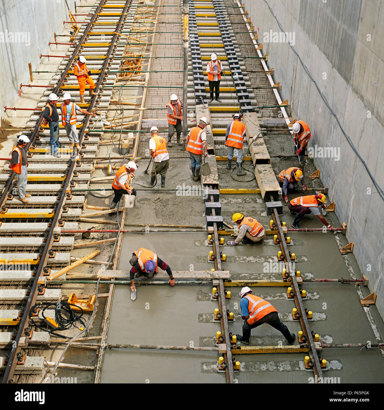 Laying rail tracks on concrete Stock Photo - Alamy