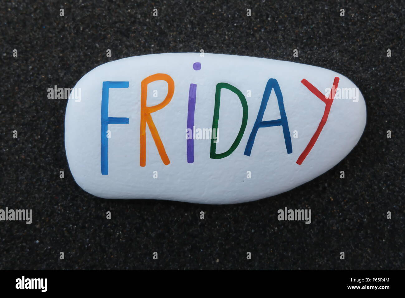 Friday, fifth day of the week carved and painted on a white stone over ...