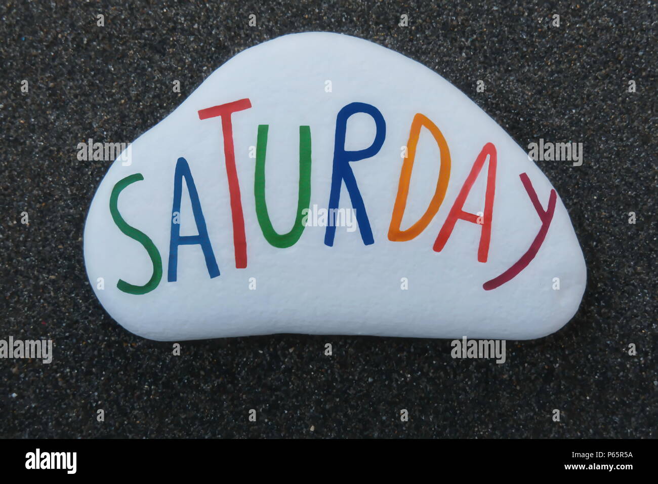 Saturday, sixt day of the week carved and painted on a white stone over ...