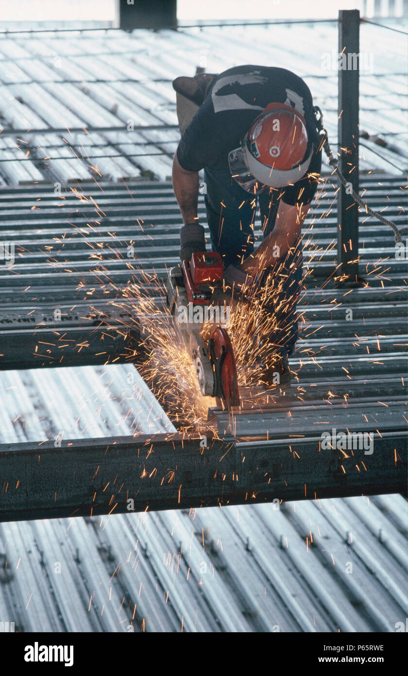 Worker cutting steel panel with circular saw Stock Photo - Alamy