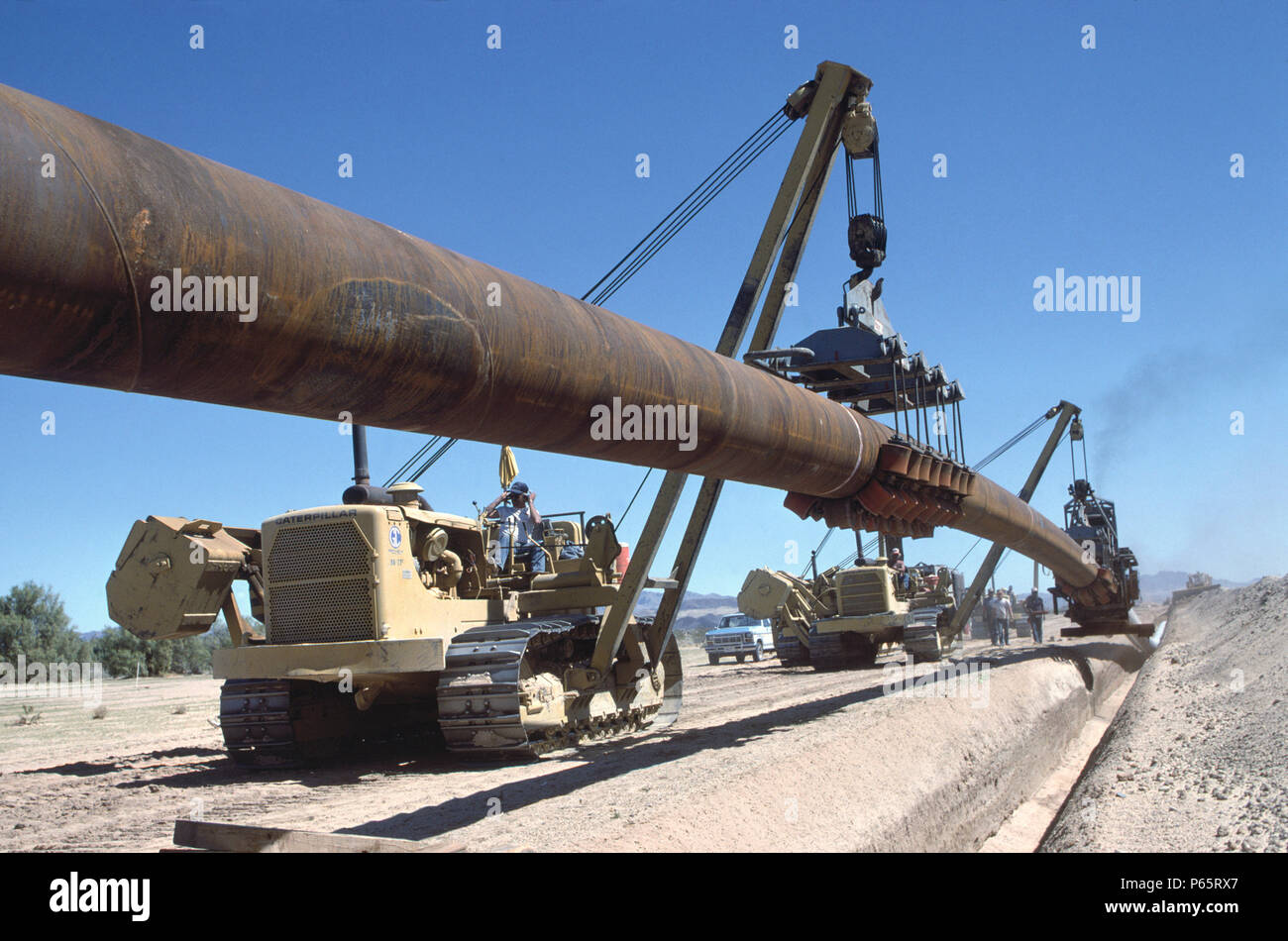 Lifting flexible pipe into trench during construction of pipeline ...