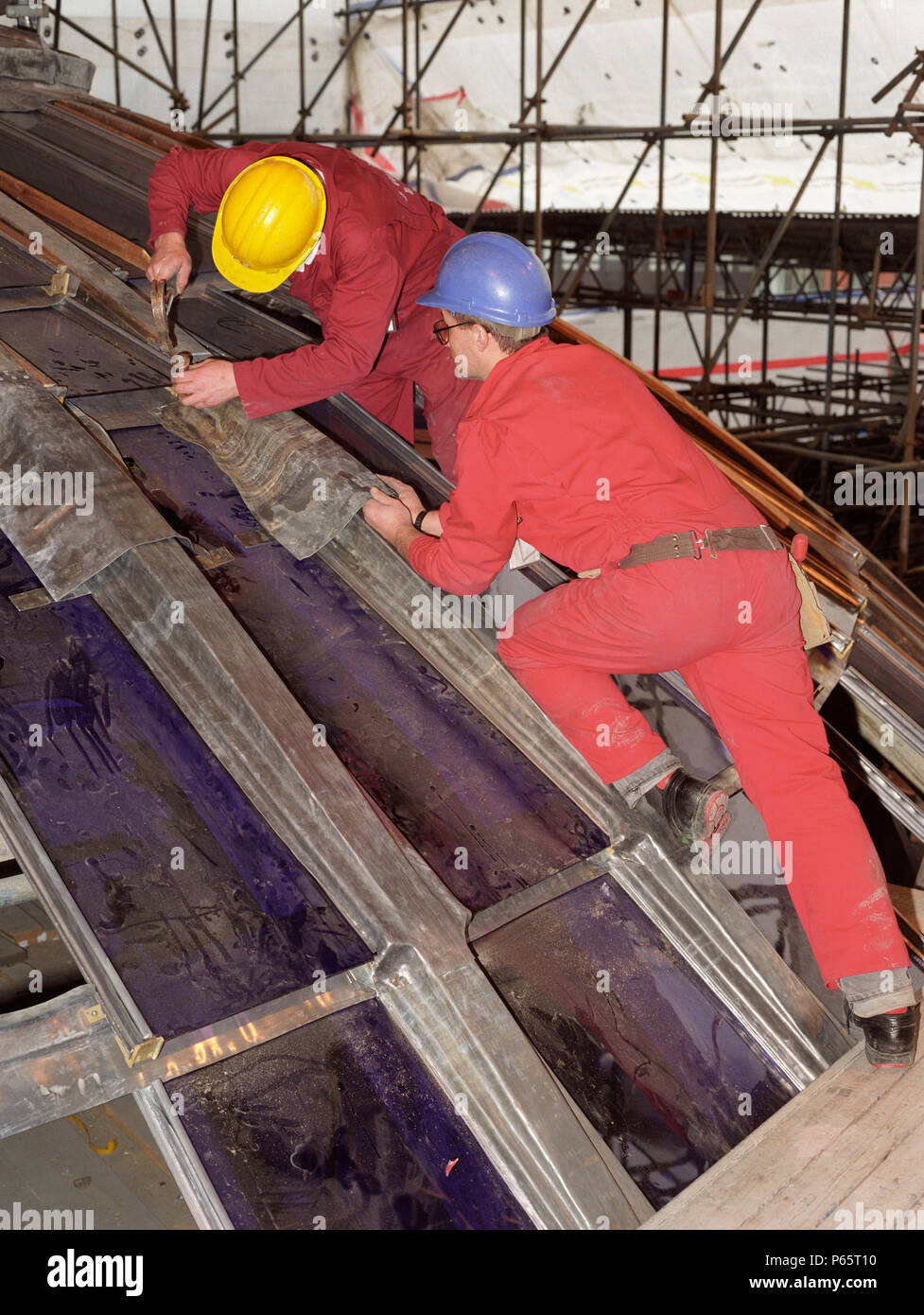 Two construction workers on a roof Stock Photo - Alamy