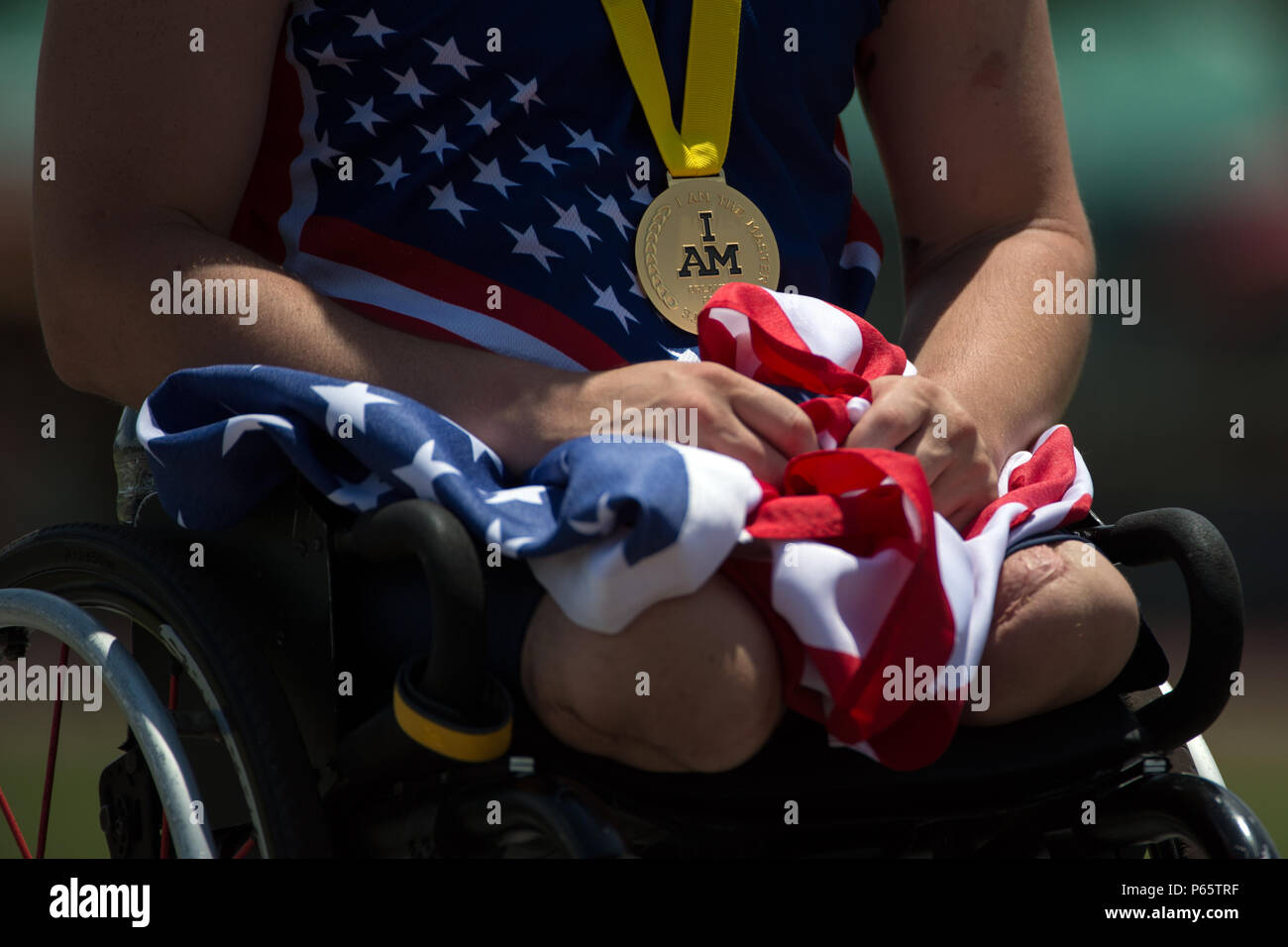 A U.S. Invictus Games team member holds an American flag after winning ...