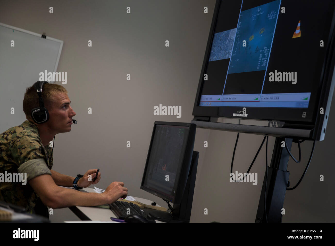 Capt. Alex Albrecht, a pilot with HMH-461 views the live feed from an ...