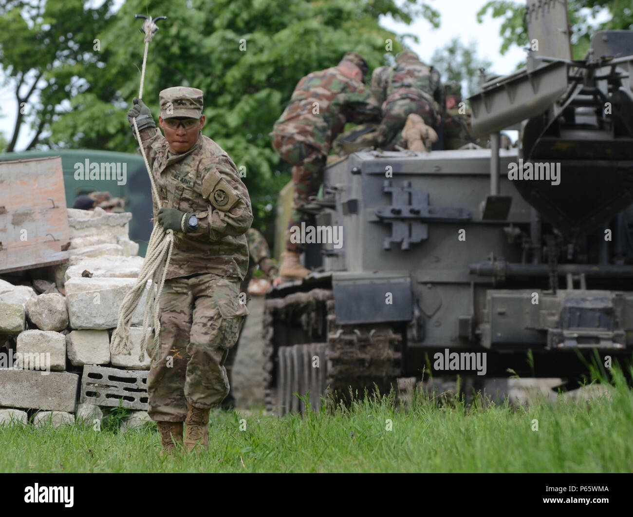 U.S. Army Sgt. Gember Brillantes, a combat engineer with the Regimental ...
