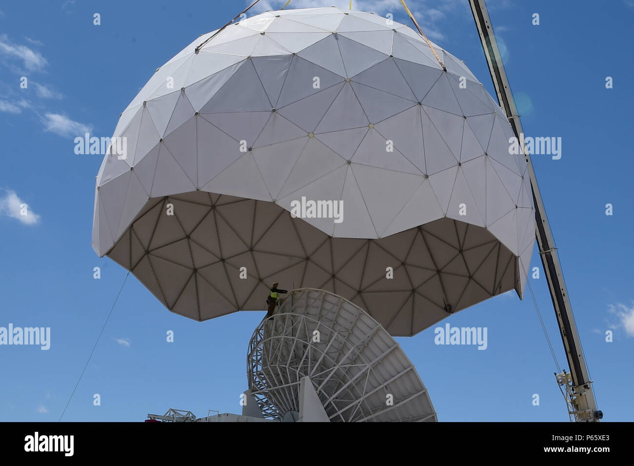 A crane removes the protective geodesic radar dome April 27, 2016, on ...