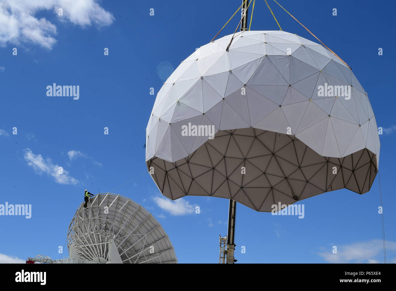 A crane removes the protective geodesic radar dome April 27, 2016, on ...