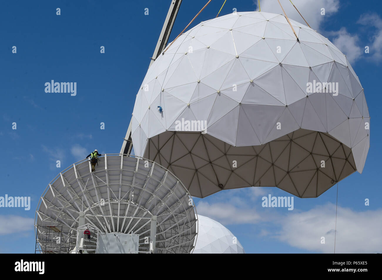 A crane removes the protective geodesic radar dome April 27, 2016, on ...
