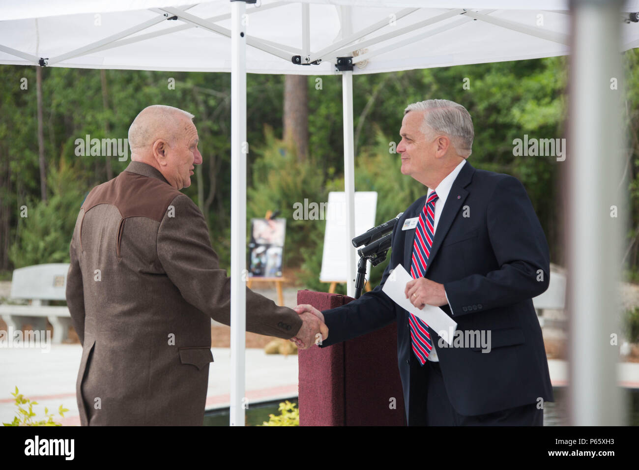 Retired U.S. Marine Corps Maj. Gen. Ray Smith, left, shakes the hand of ...