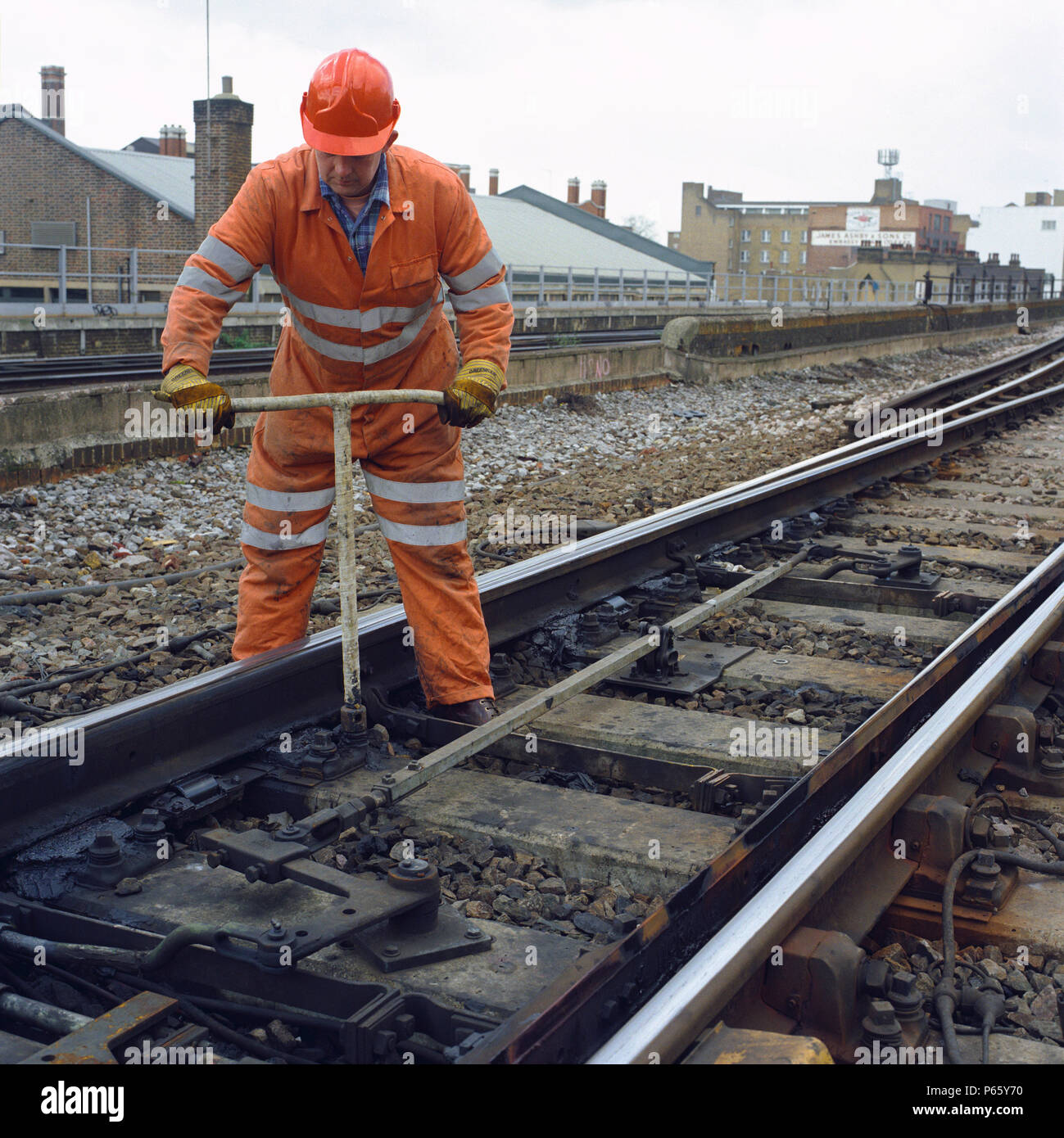 Rail worker adjusting points on railway line Stock Photo - Alamy