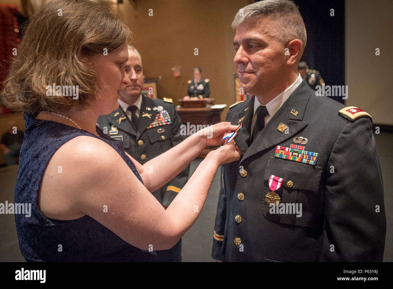 Angela Mullinax pins the retirement ribbon on her husband, (very newly ...