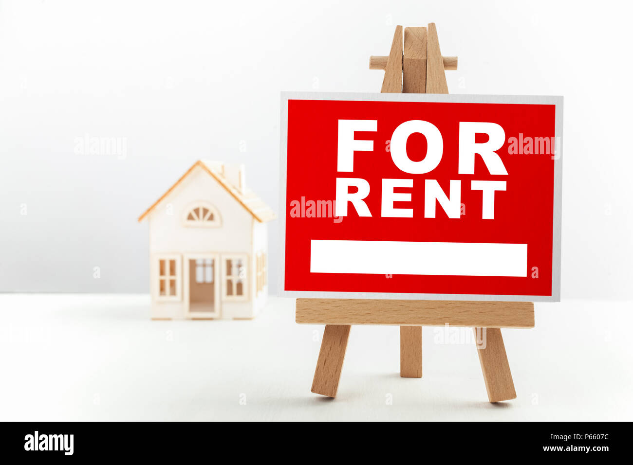 Red For Rent Real Estate Sign in Front of Small House Stock Photo - Alamy