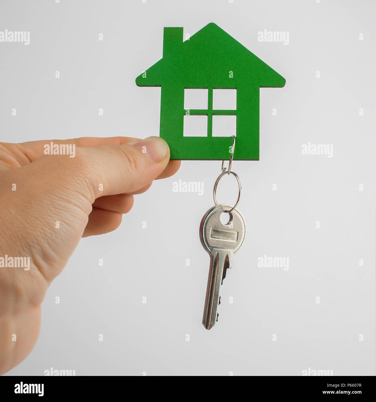 hand with key and house shape on white background Stock Photo - Alamy