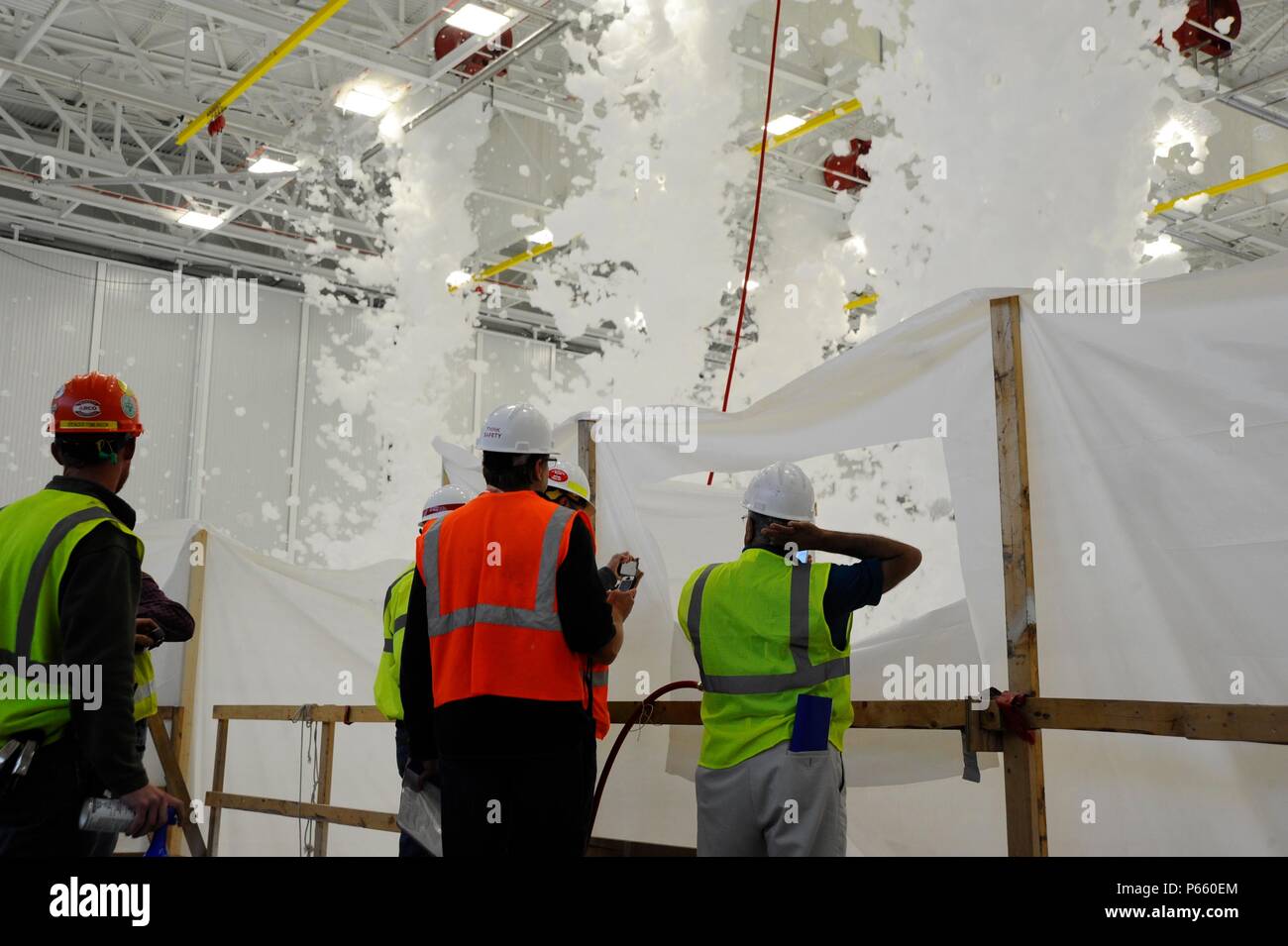 Construction contractors and KC-46 Pegasus oversight teams conduct a ...