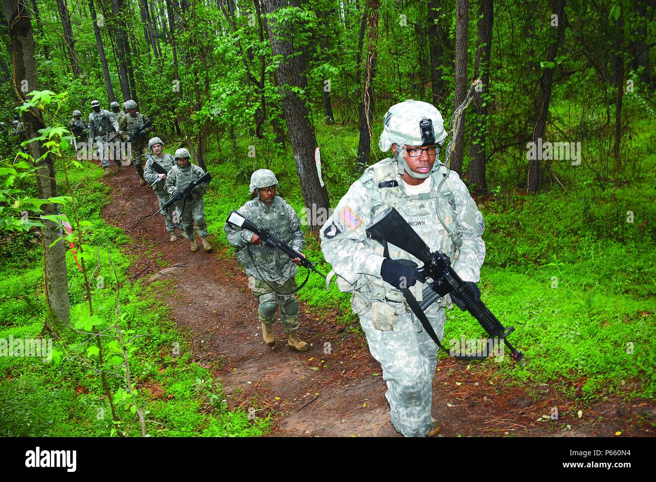 Advanced individual training Soldiers travel down a path while on ...