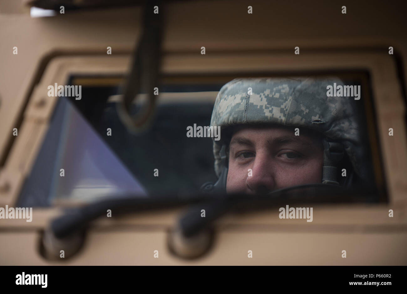 A U.S. Army Reserve Soldier observes through the window of an M1117 ...