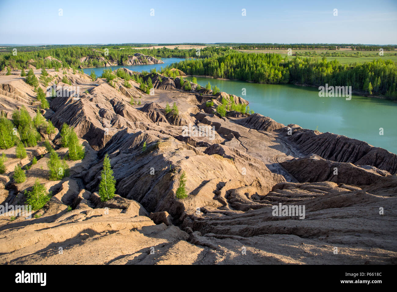Picture of hilly terrain with green trees and river Stock Photo - Alamy