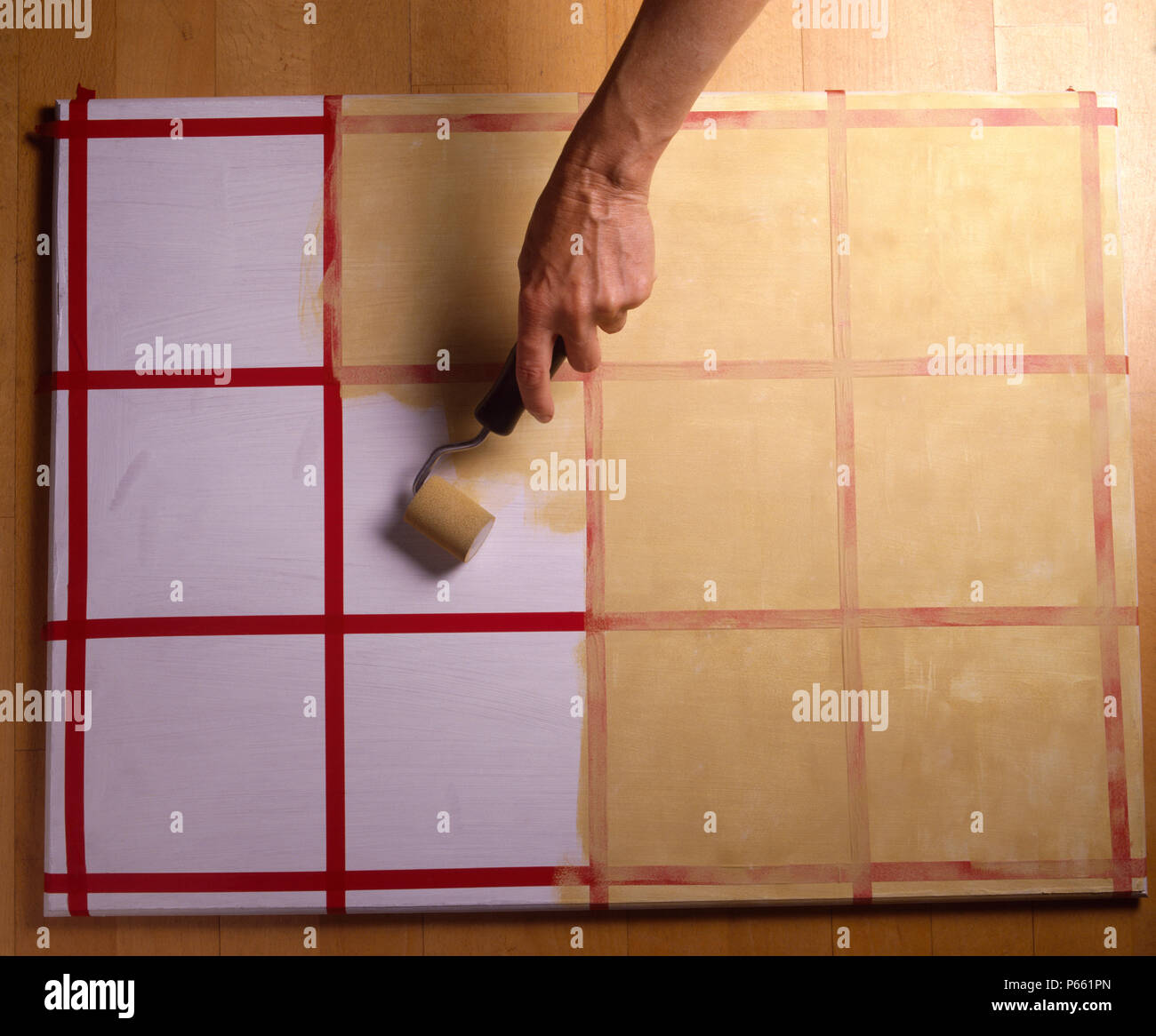 Close-up of a hand filling in squares on a grid with white paint Stock ...