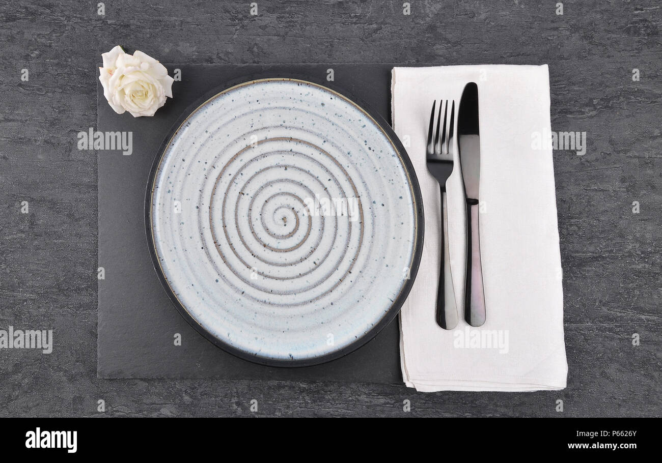 White rose and table setting on slate Stock Photo - Alamy