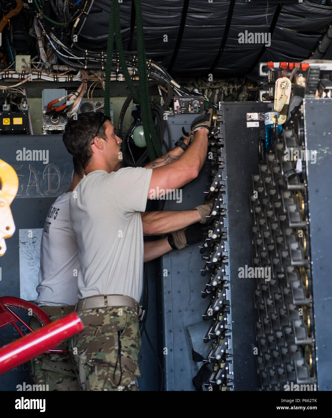 Aerial gunners with the 4th Special Operations Squadron, load 105mm and ...