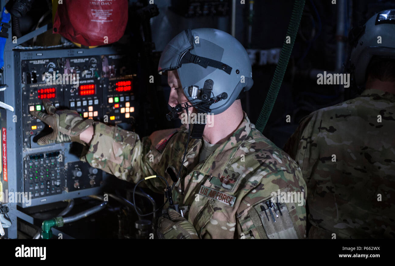 An aerial gunner with the 4th Special Operations Squadron arms the ...