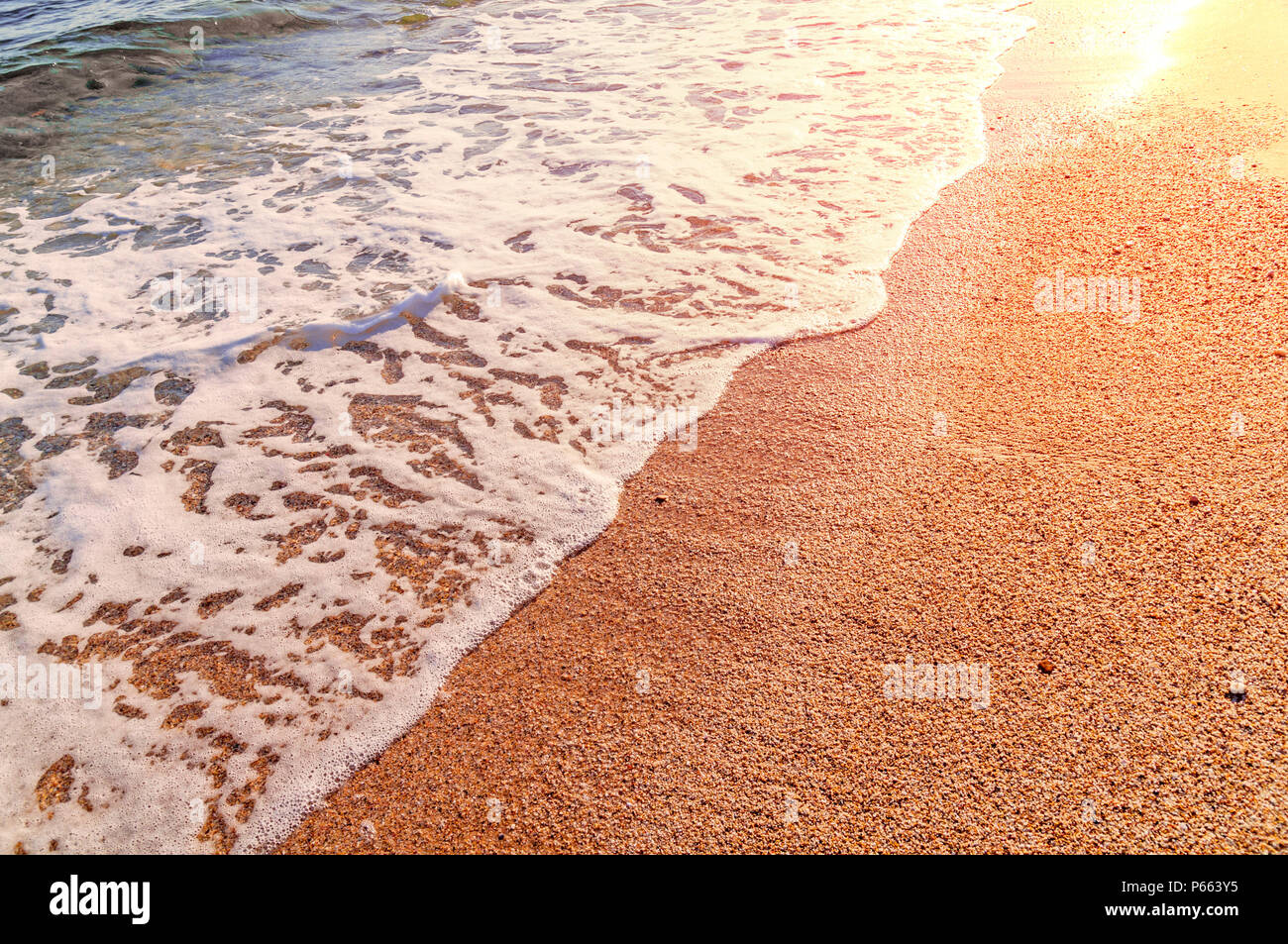 Foam wave on sea with beach background Stock Photo - Alamy