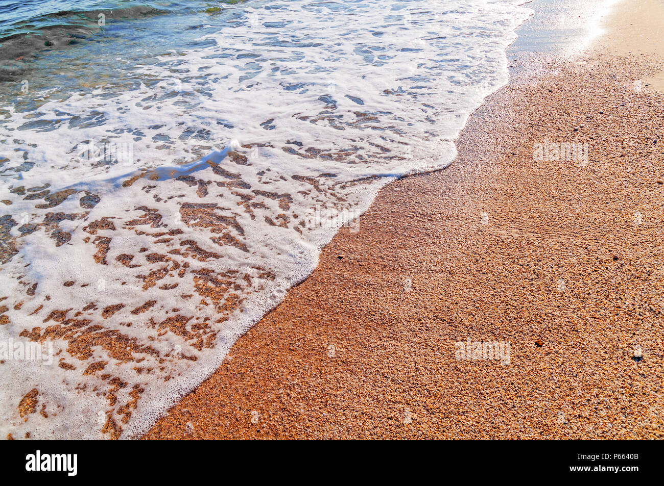 Foam wave on sea with beach background Stock Photo - Alamy
