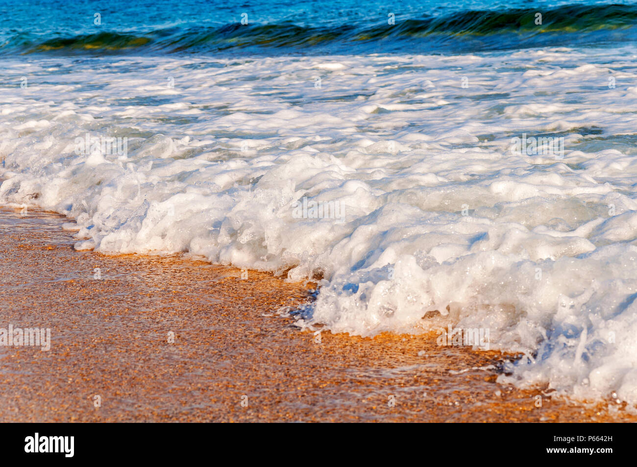 Foam wave on sea with beach background Stock Photo - Alamy