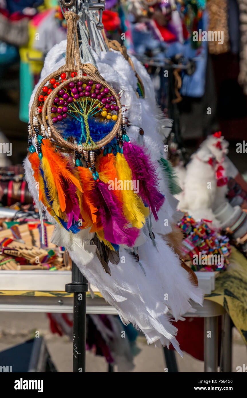National Peruvian feather jewelry is sold in the market Stock Photo - Alamy