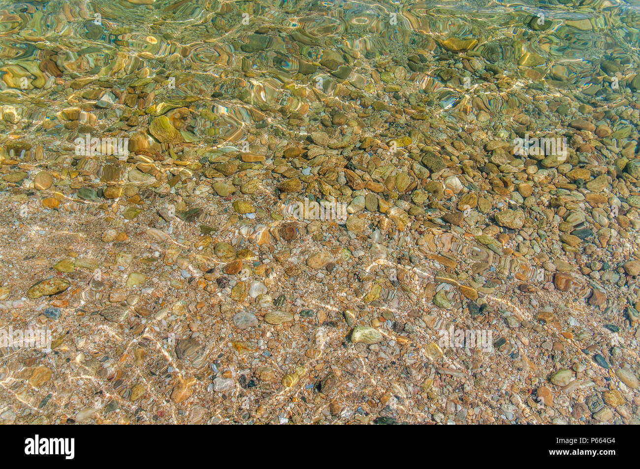 Sea pebble stone in water background Stock Photo - Alamy