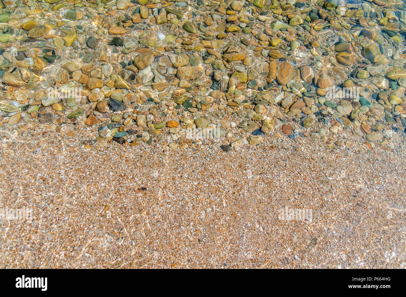 Sea pebble stone in water background Stock Photo - Alamy