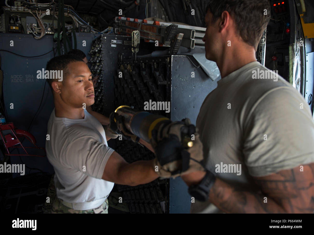 U.S. Air Force special missions aviators from the 4th Special Operations Squadron store 105mm ...