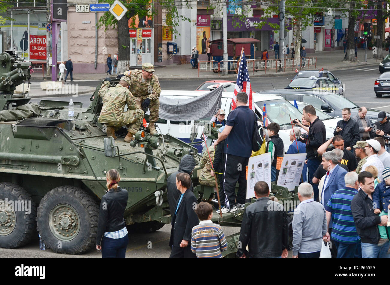 A crowd of Moldovan citizens gather around a U.S. Army Engineer Squad ...