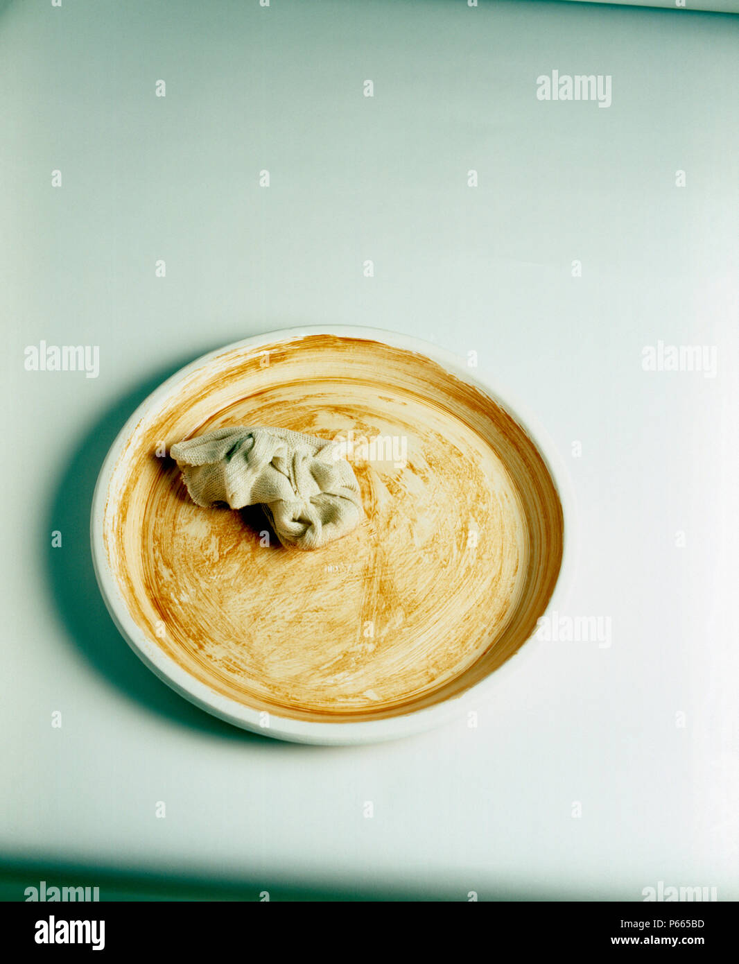 Close-up of plate with bunched rag for ragging paint-effect Stock Photo ...