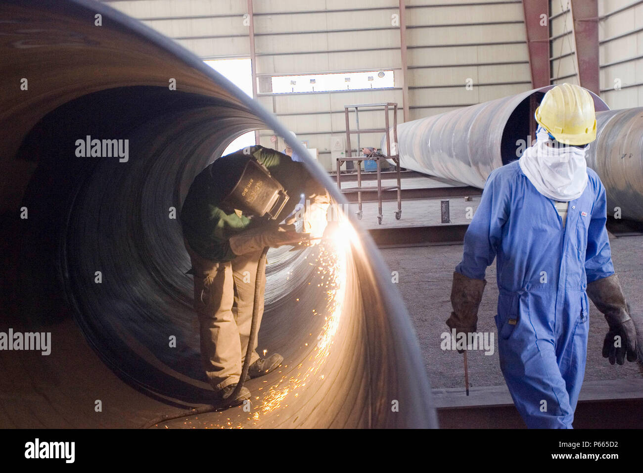 Workers at Hyojong Pipe factory, Doha Stock Photo - Alamy