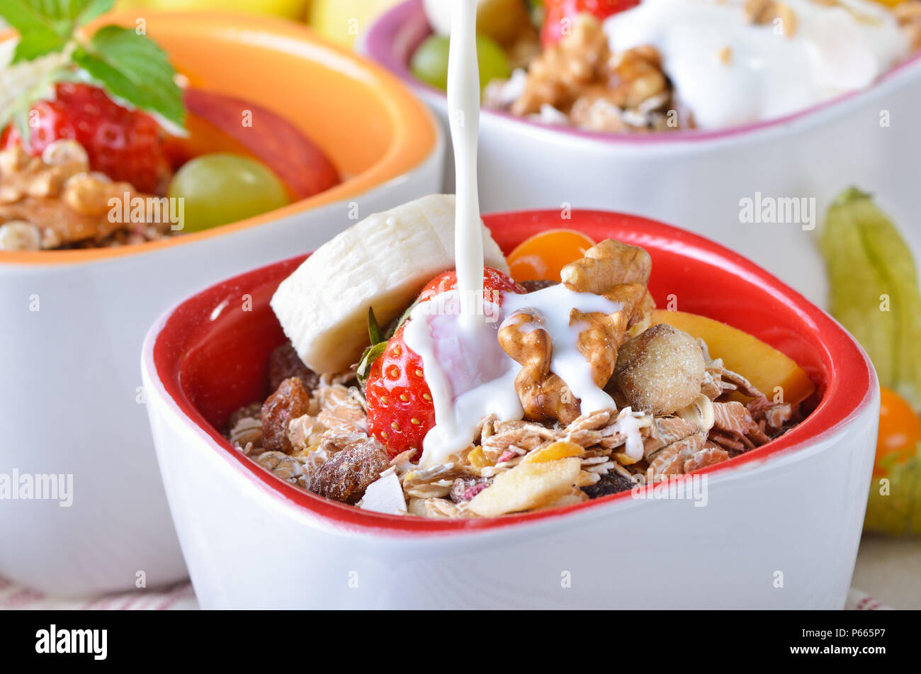 Organic muesli with fresh fruit and milk Stock Photo - Alamy