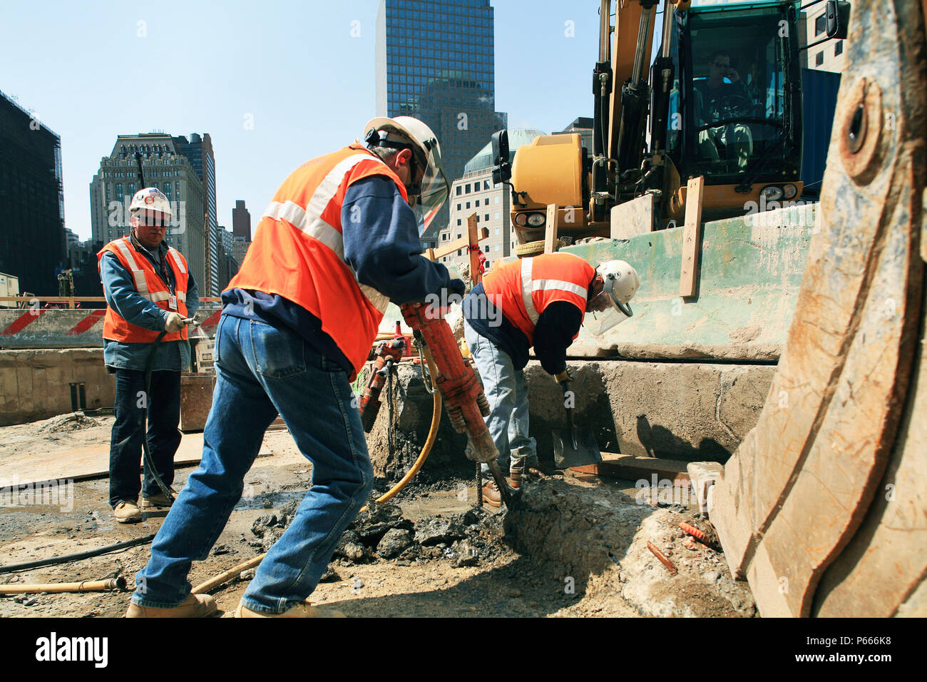Workers drill and shovel near Tower One at World Trade Center site ...