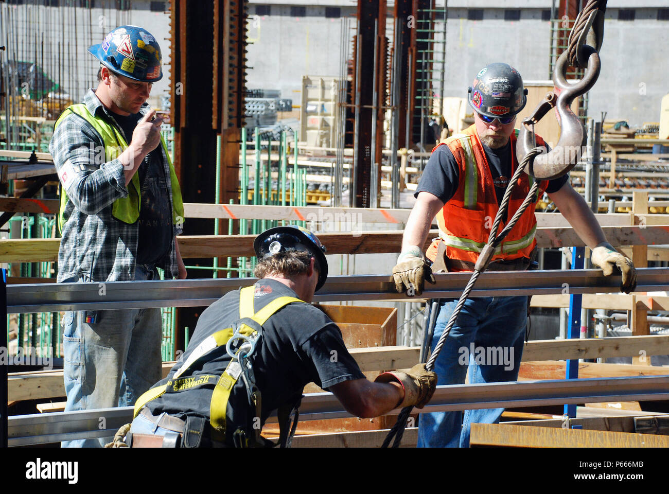 Workers prepare to hoist a piece of steel at Tower One site, Lower ...