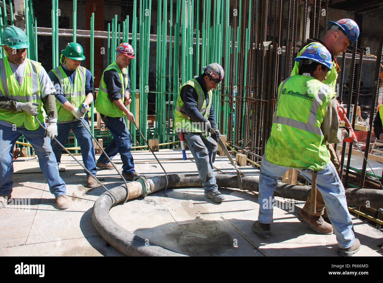 Workers move the concrete pump hose at Tower One site, Lower Manhattan ...