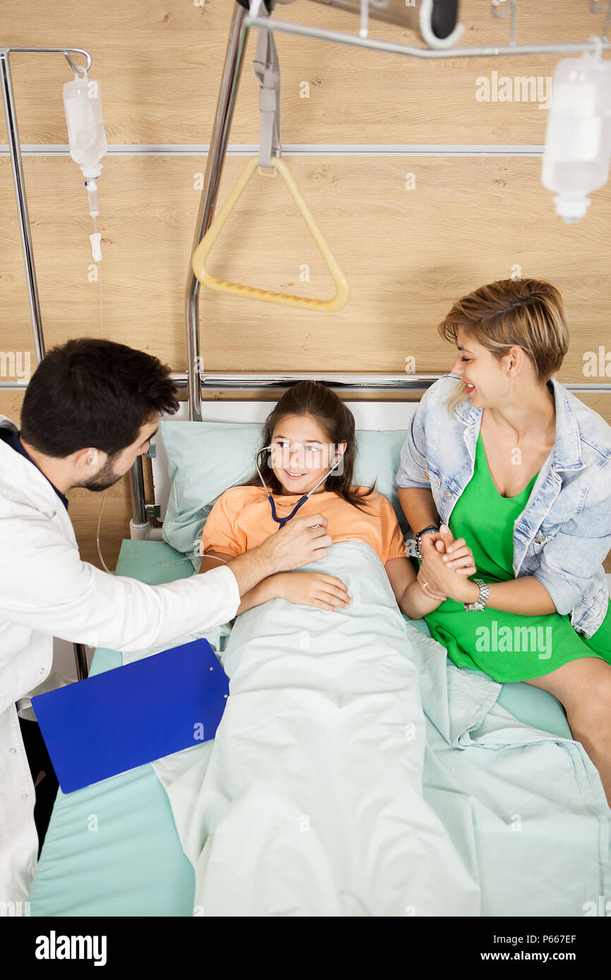 Doctor checking her patient heart Stock Photo - Alamy
