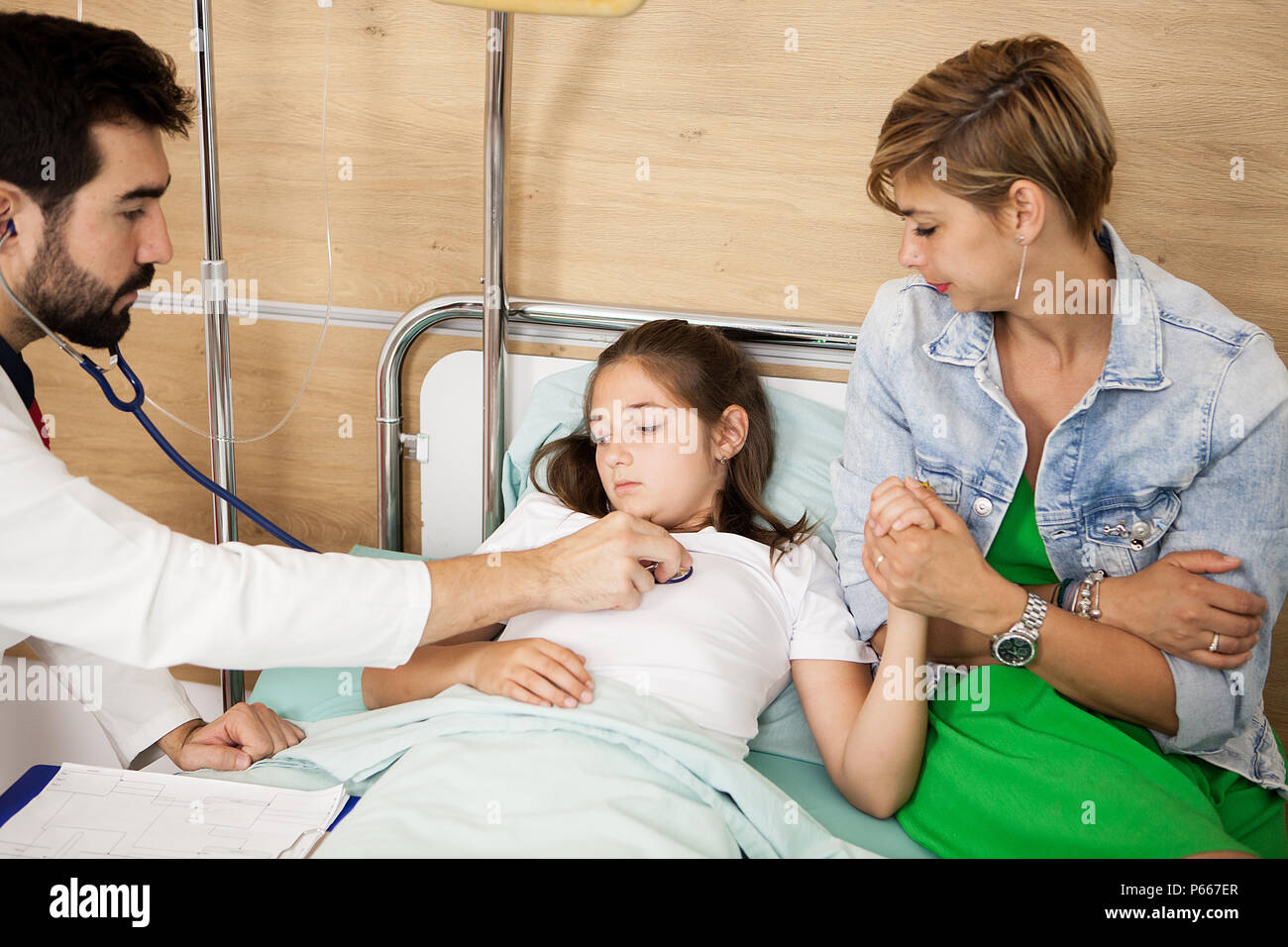 Doctor checking her patient heart Stock Photo - Alamy