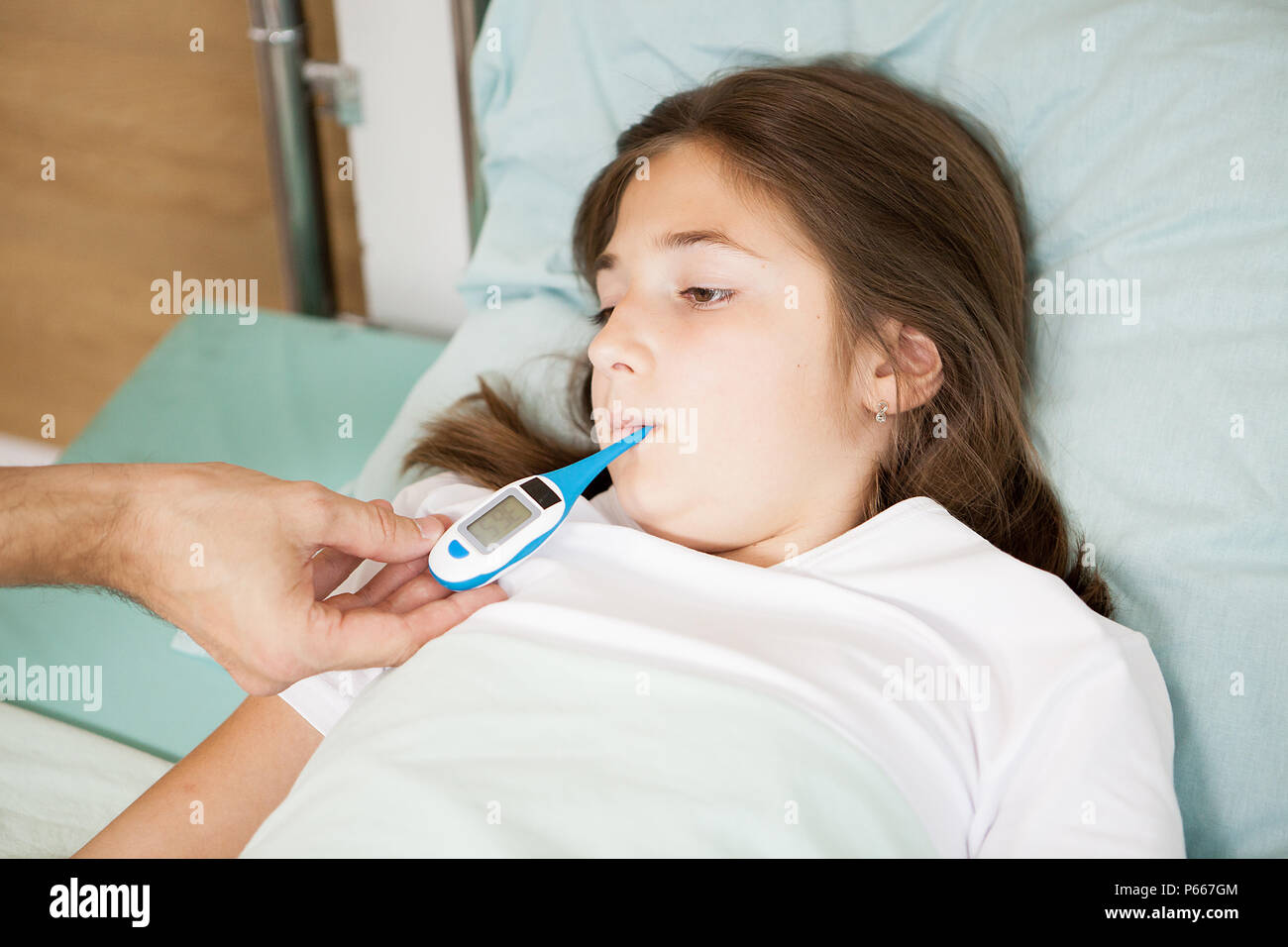 Doctor taking body temperature of her patient Stock Photo - Alamy